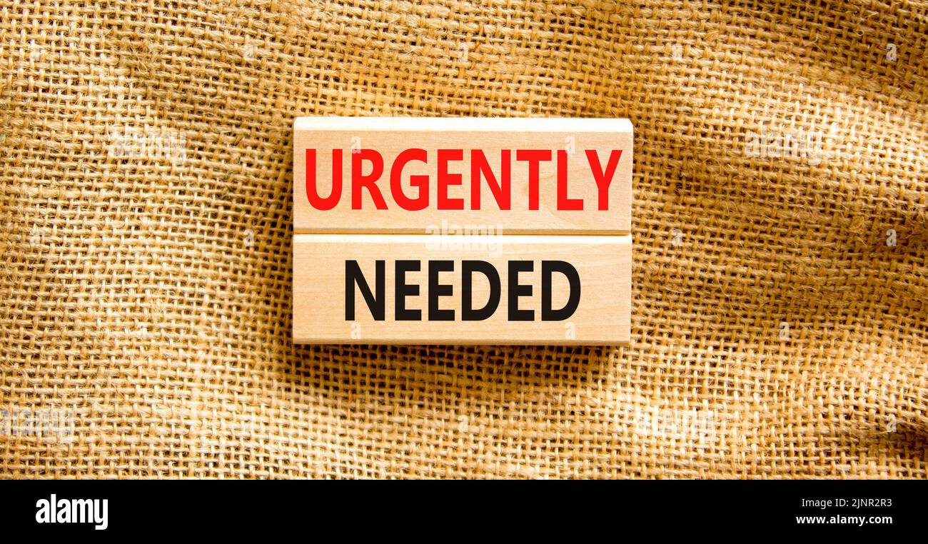Urgently needed symbol. Concept words Urgently needed on wooden blocks ...