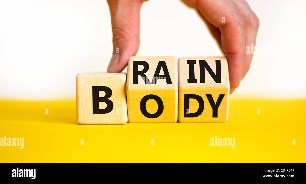 Body vs brain symbol. Businessman turns wooden cubes and changes ...