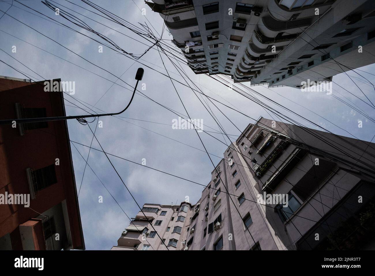 Cables stand out between tall buildings, picture taken in Tirana, May ...