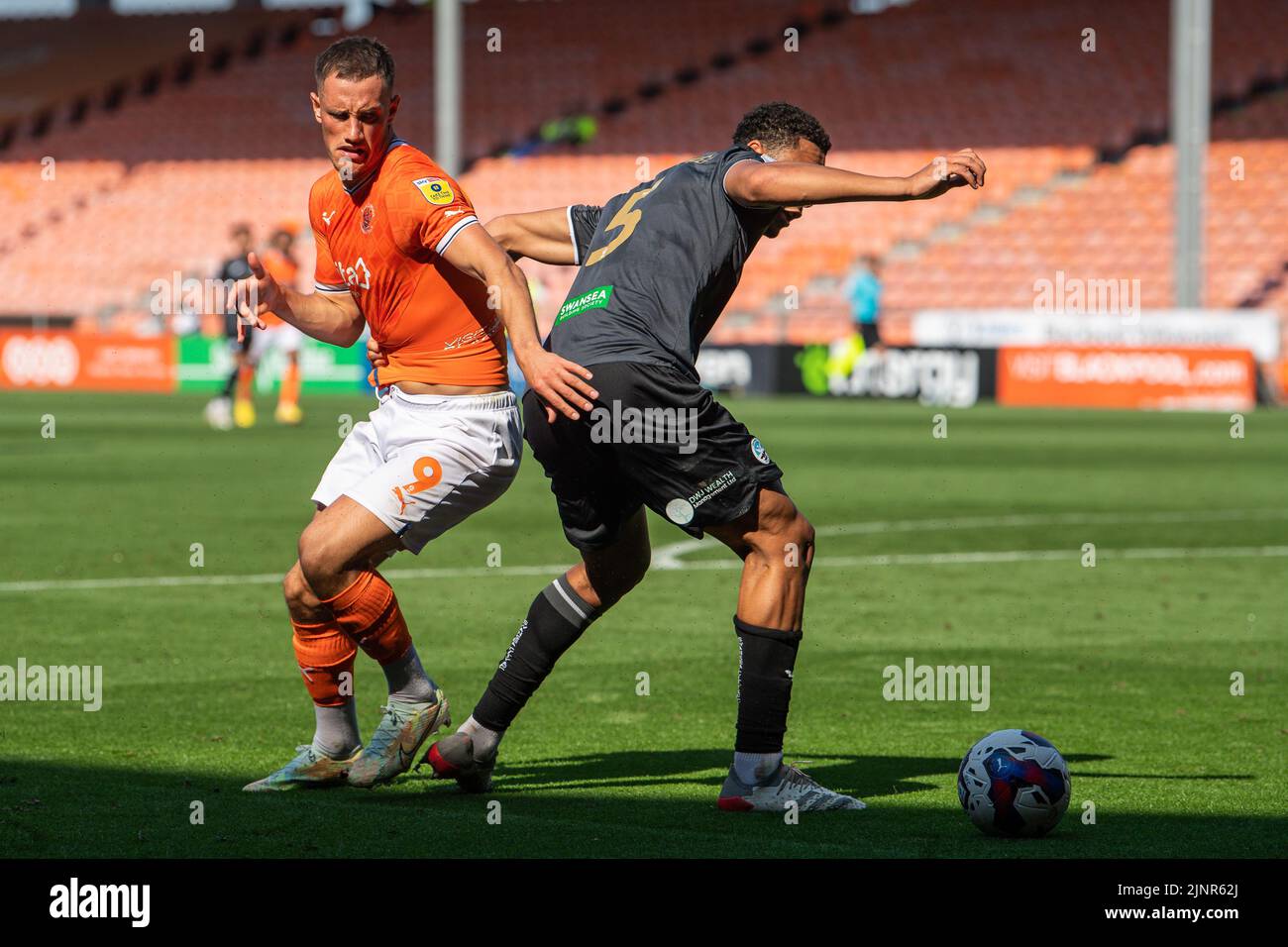 Jerry Yates #9 of Blackpool and Ben Cabango #5 of Swansea City battle ...