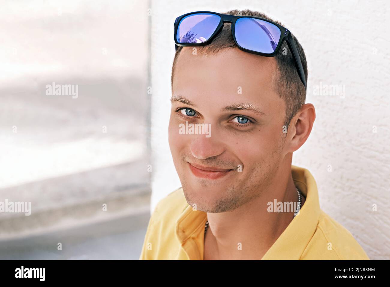 Portrait young happy blue eyes male millennial smiles looking into the ...