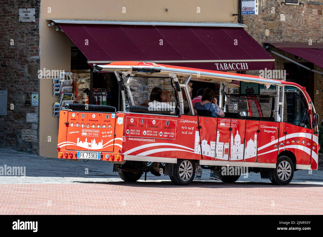 A tourist 'hop on hop off' bus on the street in Montepulciano, Italy ...