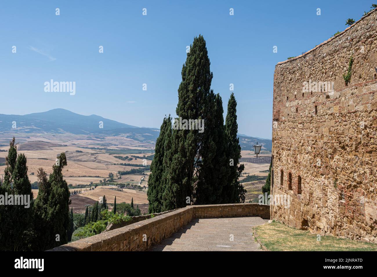 A view along the walkway above the walls of Pienza with a view across ...