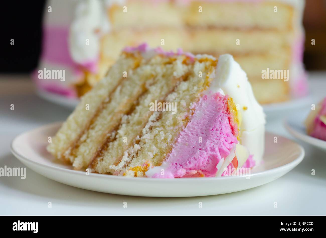 Moist madeira sponge, layered with plum and raspberry jam, coated and ...