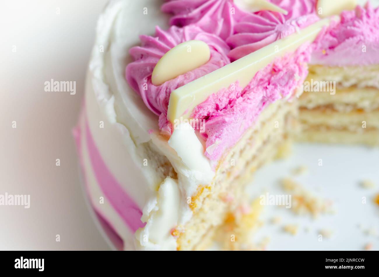 Moist madeira sponge, layered with plum and raspberry jam, coated and ...