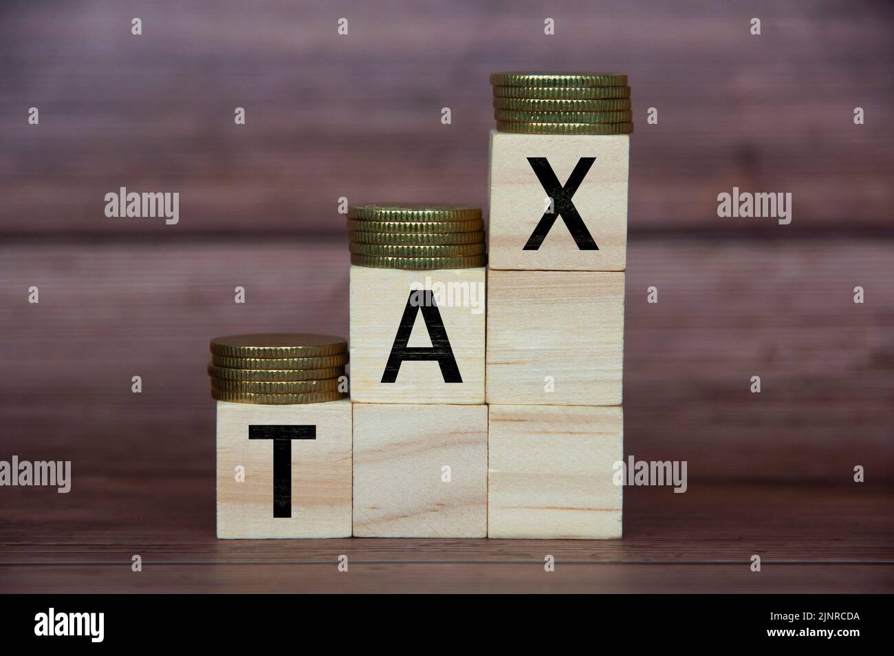 Tax word on wooden blocks with gold coins on top. Tax concept Stock ...