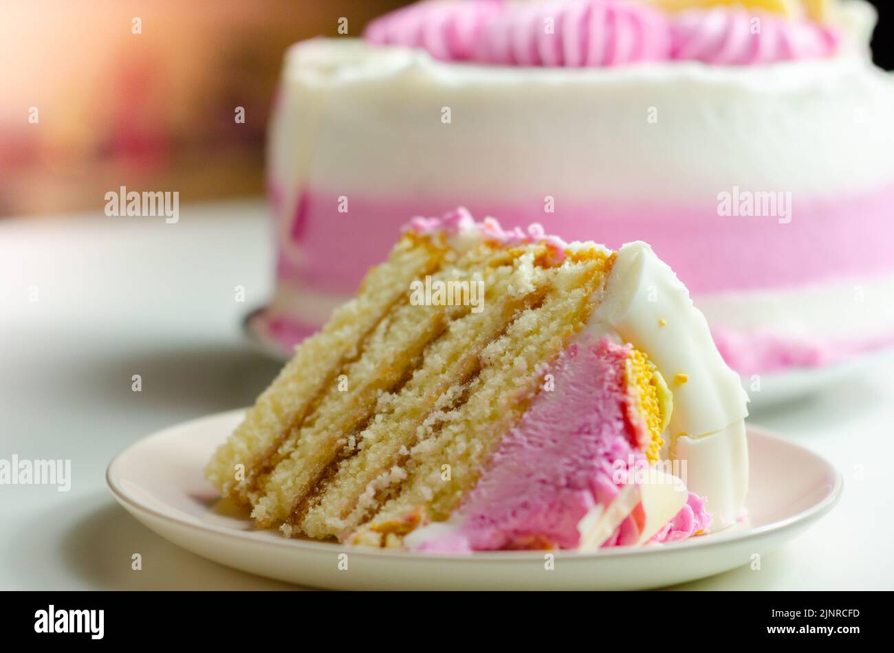 Moist madeira sponge, layered with plum and raspberry jam, coated and ...