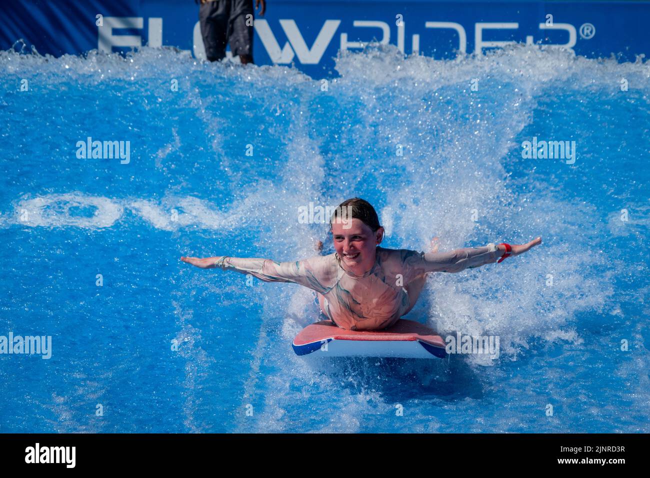 Phuket, Thailand. 13th Aug, 2022. A kid strikes a pose on the FlowRider ...