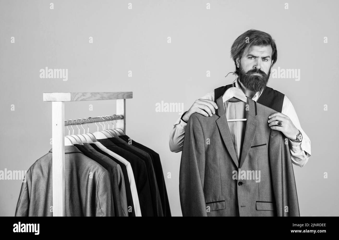 Shopper hipster man in fitting room menswear store, try on a suit ...