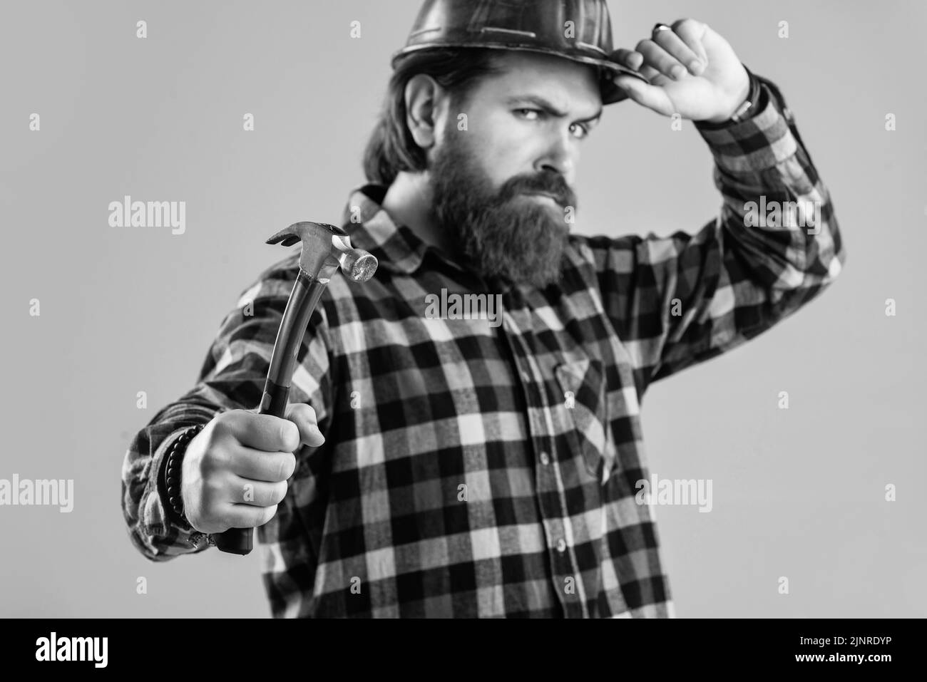 Mature construction worker repairing Black and White Stock Photos ...