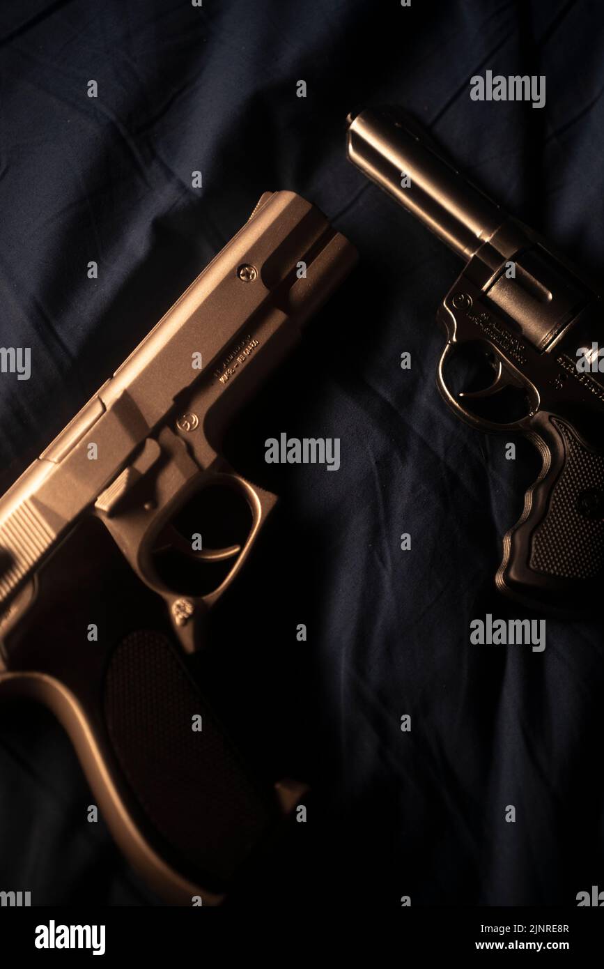 Pistol gun on bed sheet still life crime thriller book cover design ...