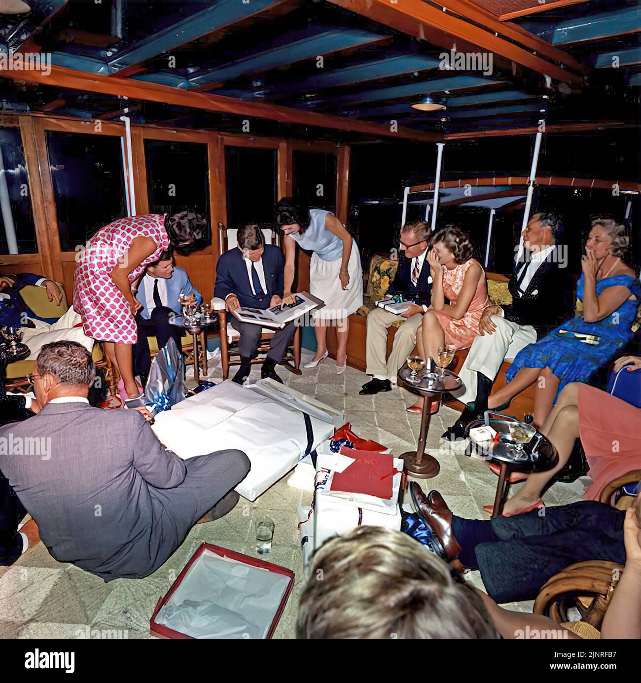 President John F. Kennedy opening gifts with family and friends on ...