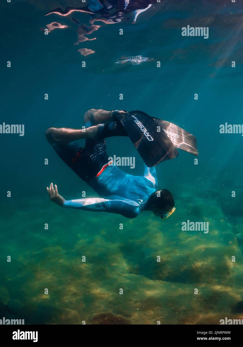 August 07, 2021. Varna, Bulgaria. Men freediver dive with fins in sea ...