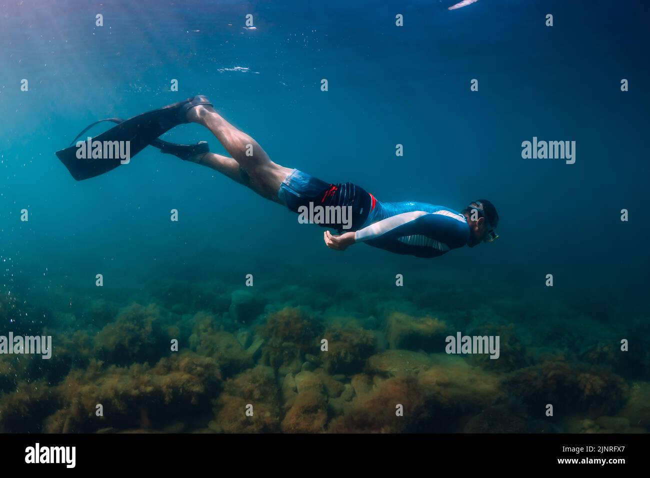 August 07, 2021. Varna, Bulgaria. Men freediver dive with fins in sea ...