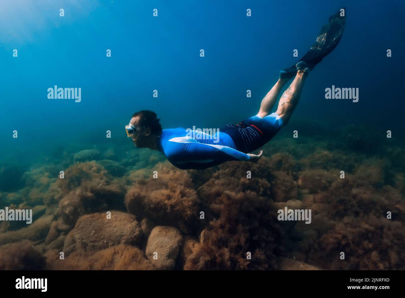 August 07, 2021. Varna, Bulgaria. Men freediver dive with fins in sea ...