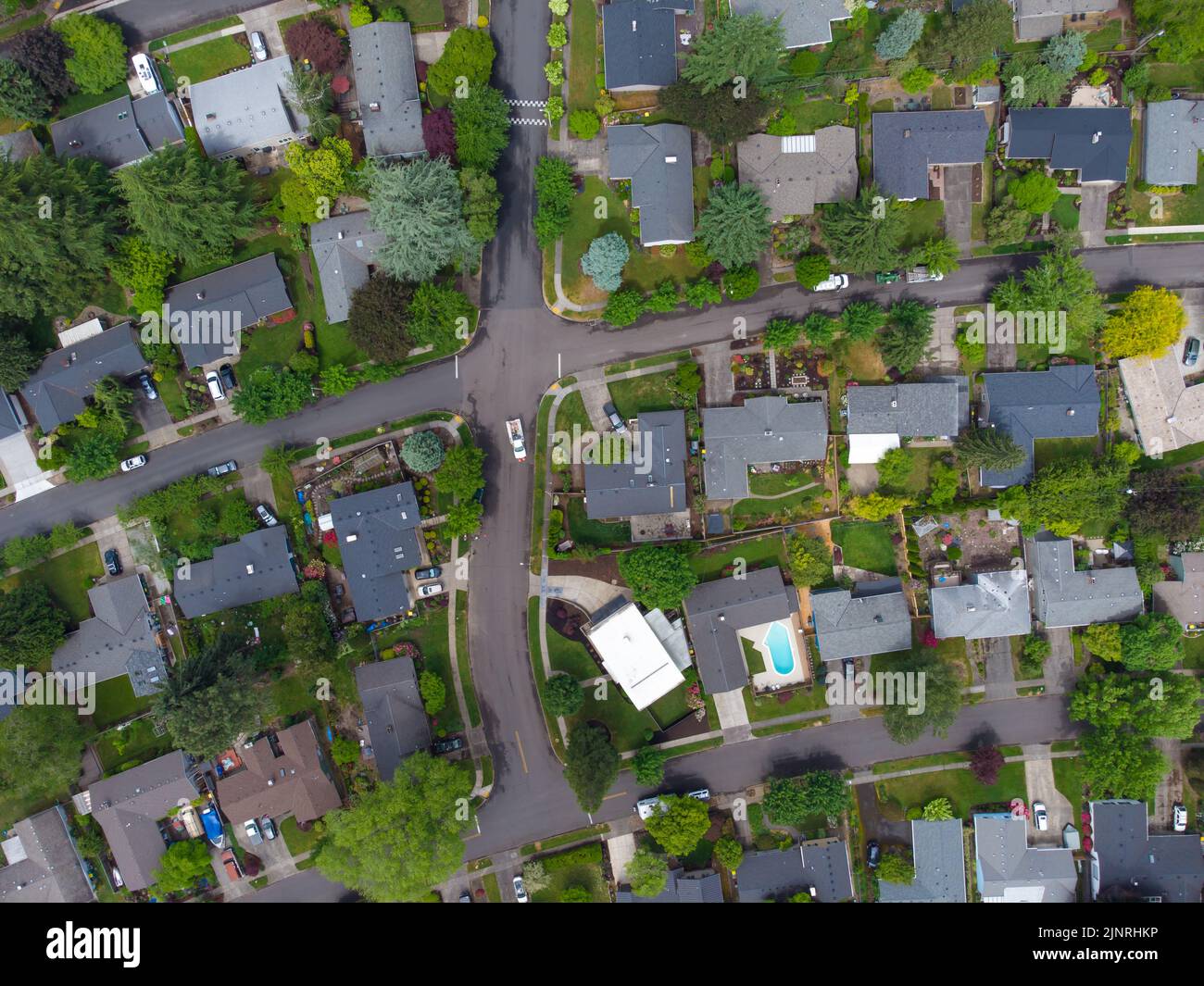 Shooting from a drone. Small green town, suburb with developed ...