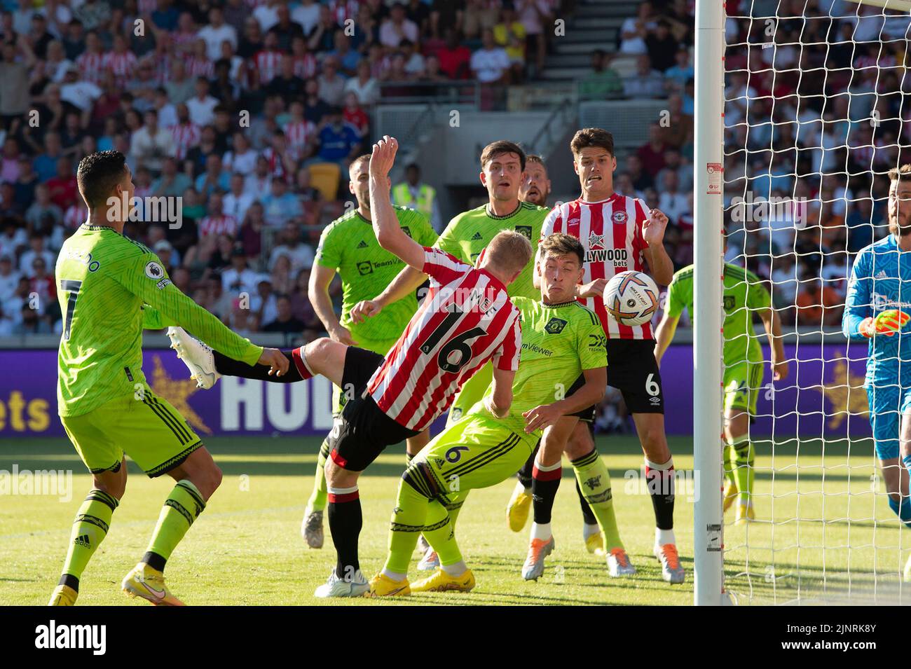 London, UK. 13th Aug, 2022. Ben Mee of Brentford scores his side third ...