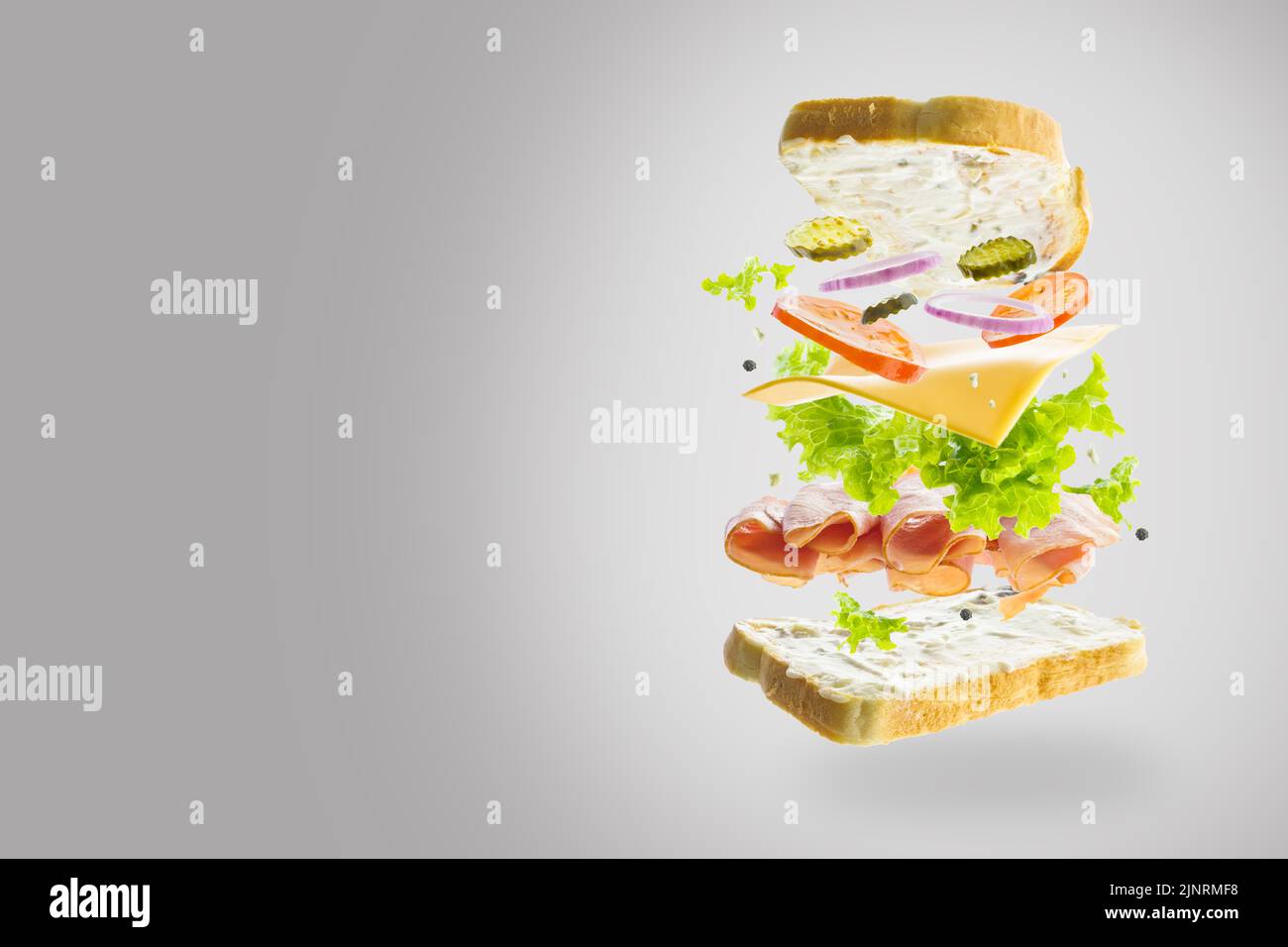 Creative composition. Sandwich in frozen flight on a light gray ...