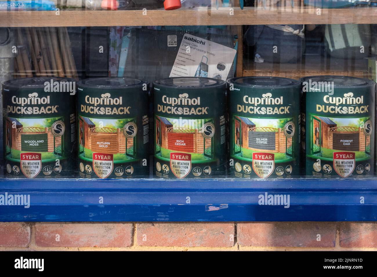 Cuprinol Ducksback, tins of wood stain in a shop window, England, UK ...