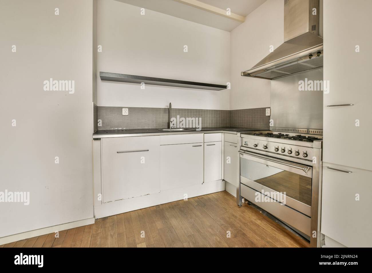 Interior of empty white kitchen with windows and wooden parquet floor ...