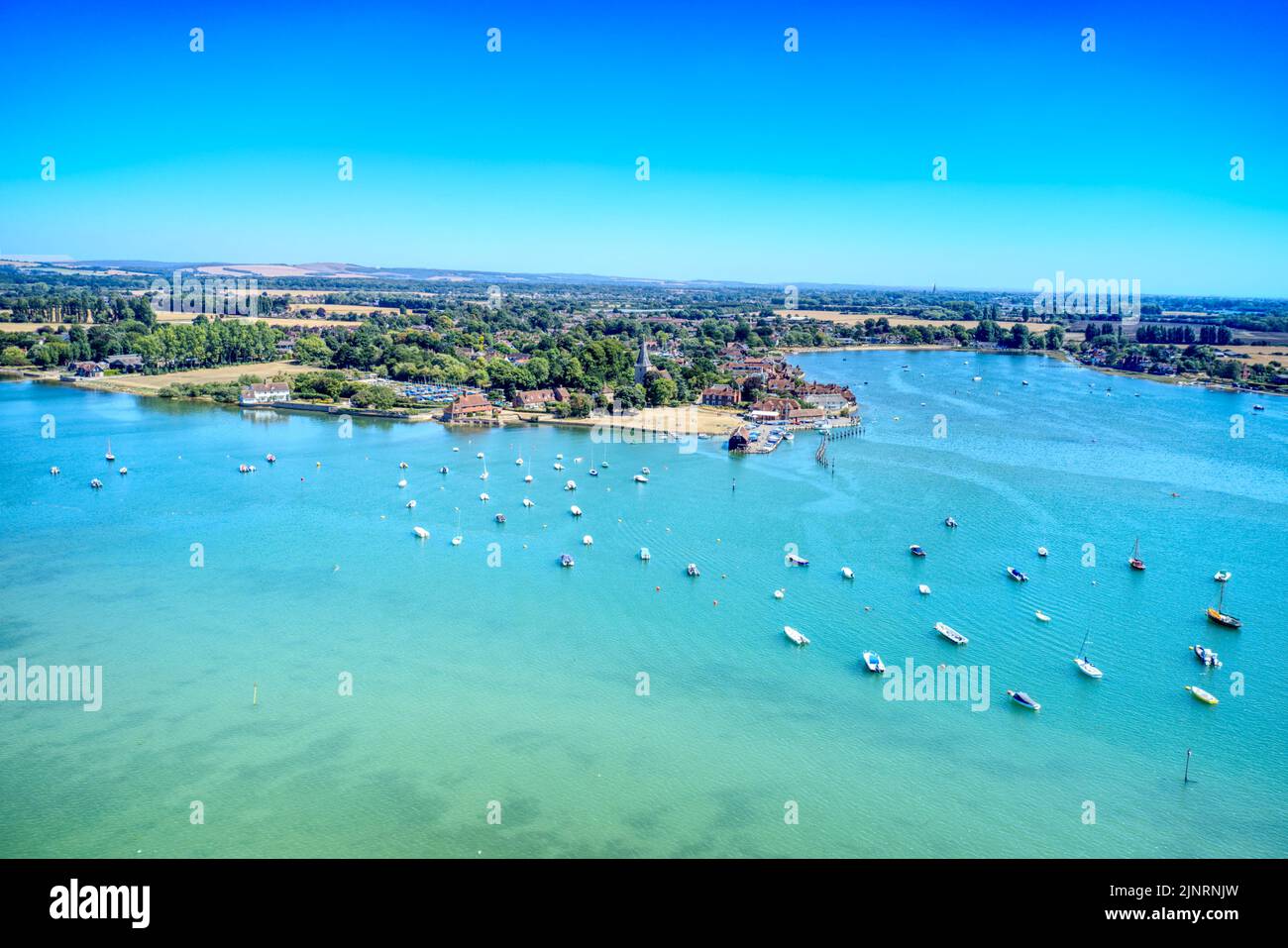 Aerial view over small boats and Sailing Dinghies anchored in the ...