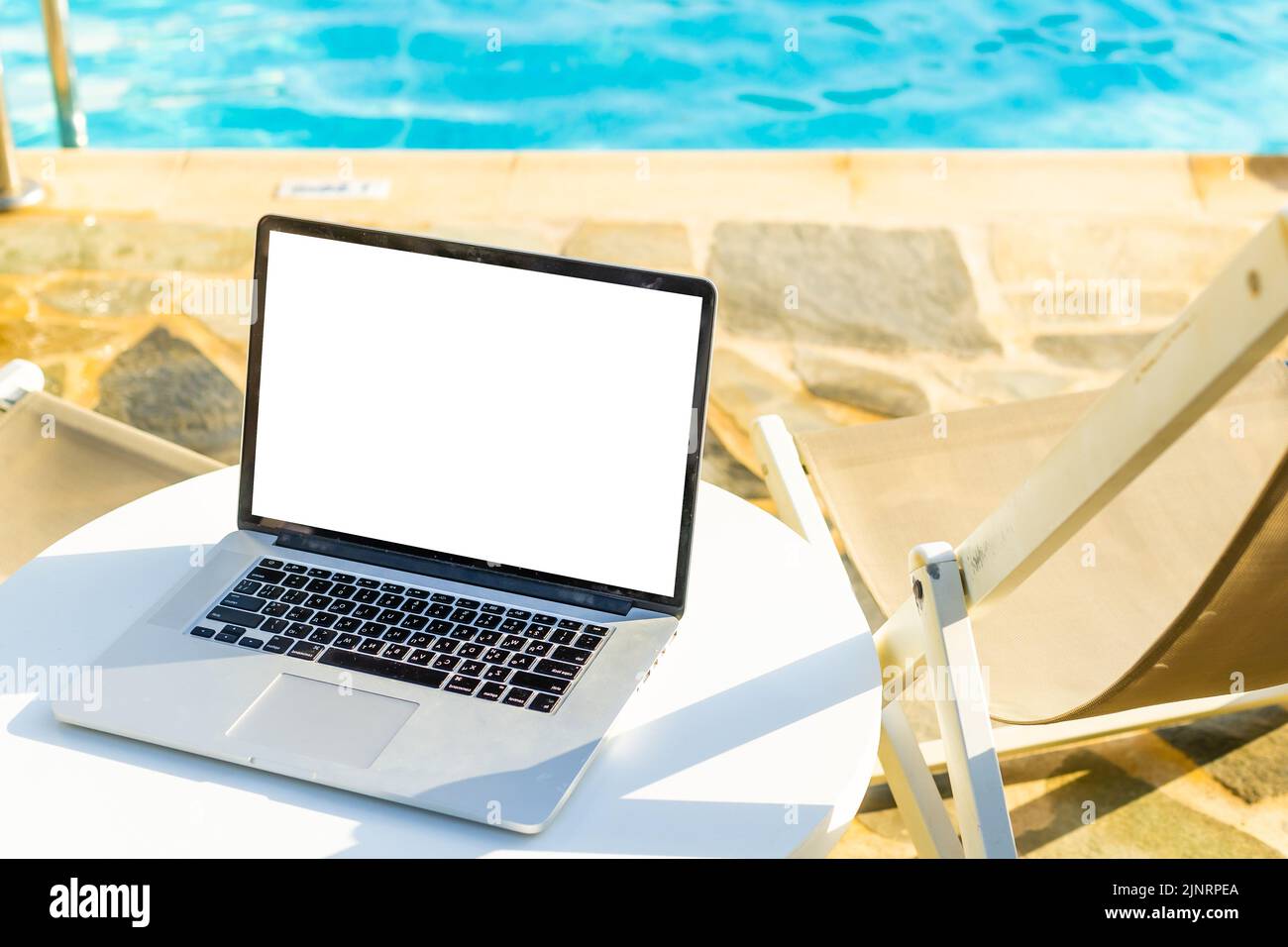 grey laptop computer open with keyboard on deckchair Stock Photo - Alamy