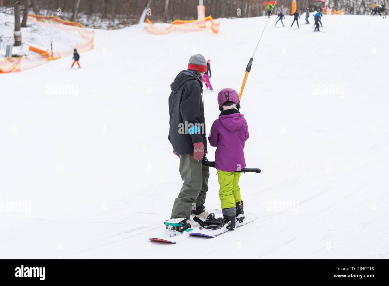 Ski Resort Father Teaching Little Daughter Snowboarding Stock Photo - Alamy