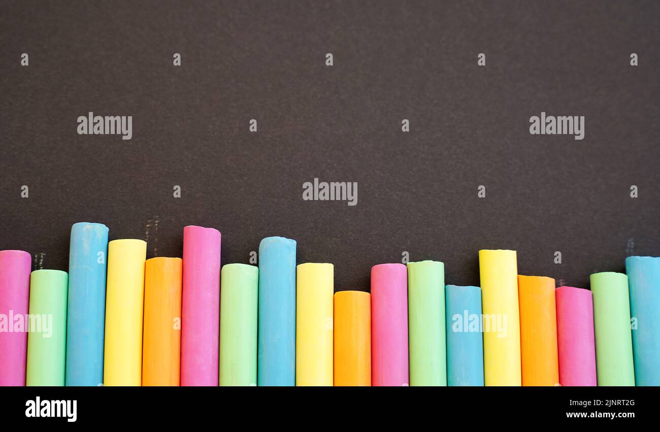 Colored chalk on black background. Education concept. Back to school ...