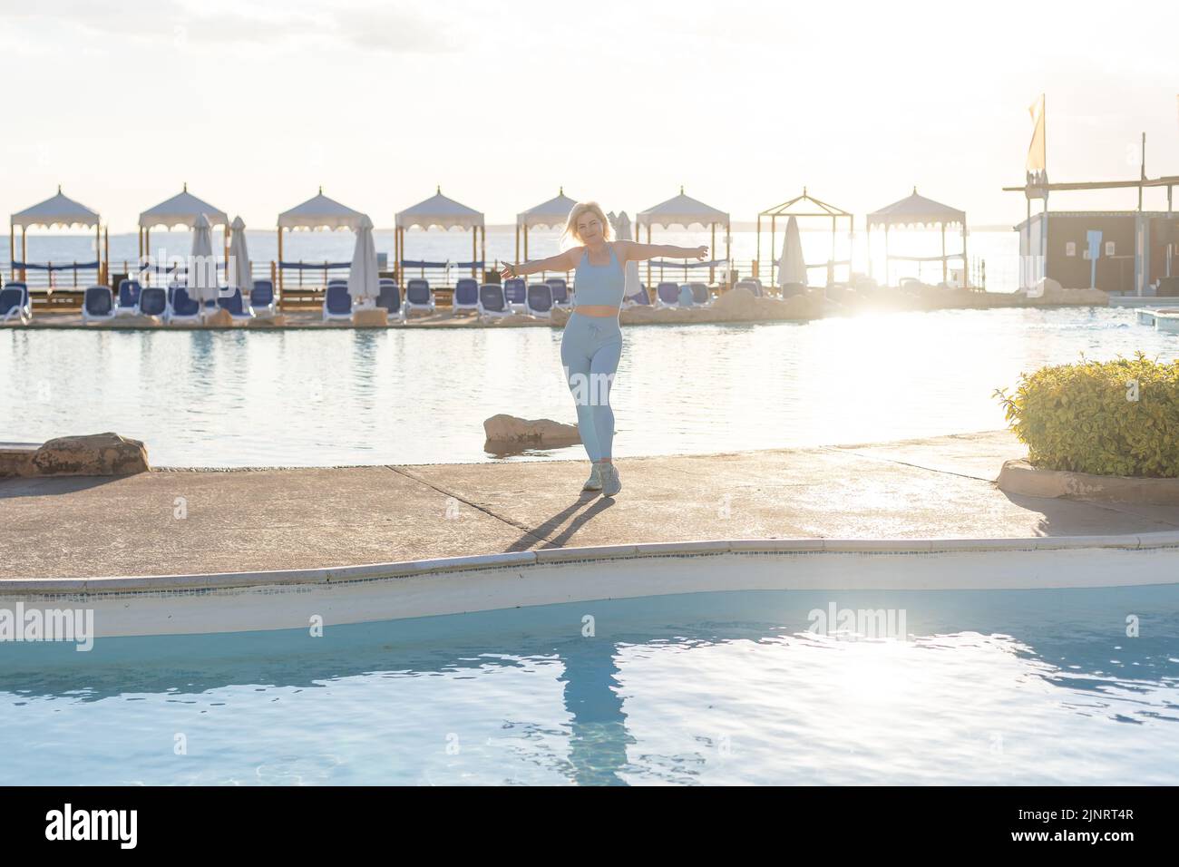 Good morning with yoga meditating on sunrise background. Active woman ...