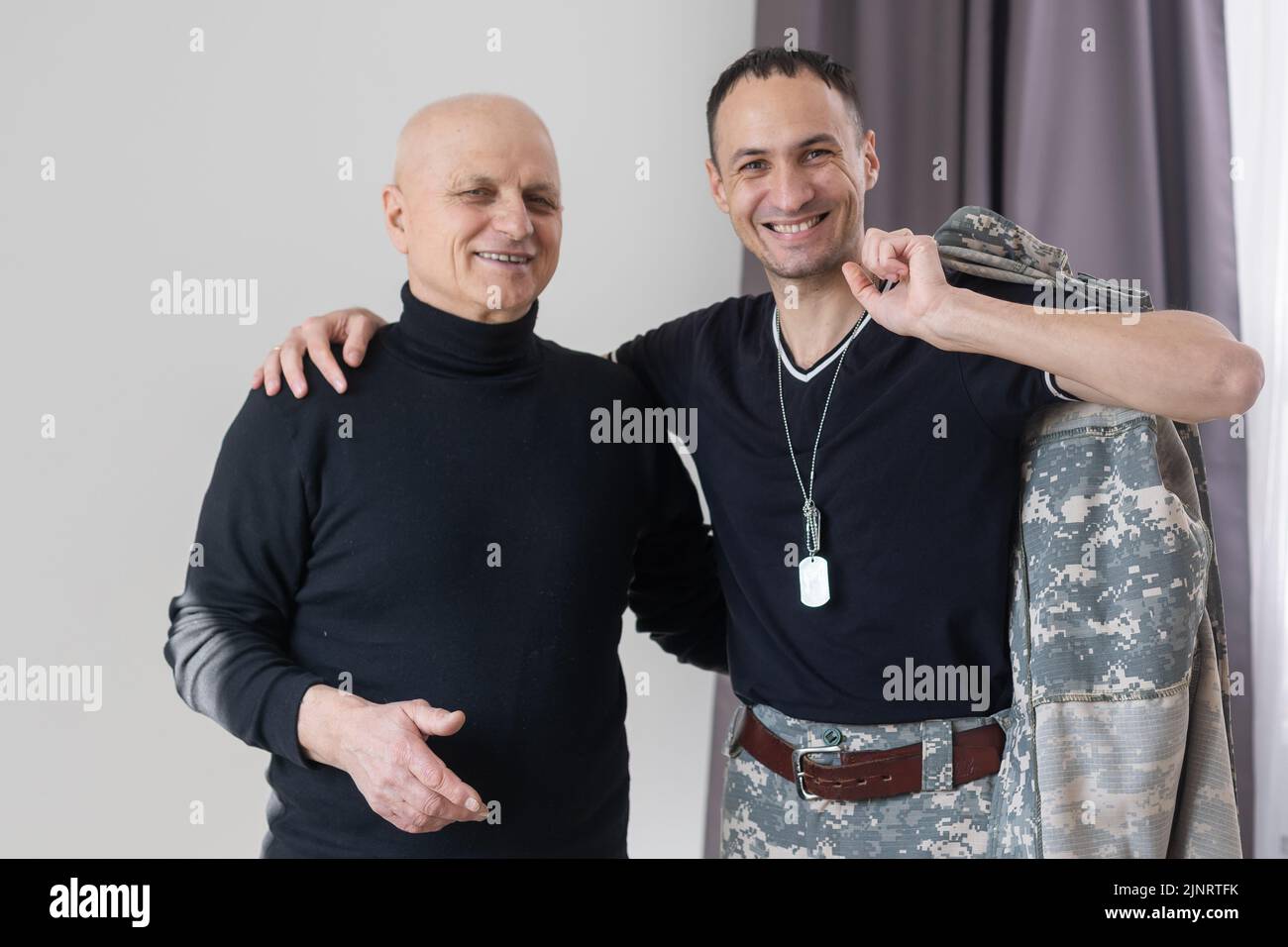 Portrait of army man with parents, elderly father and military son ...