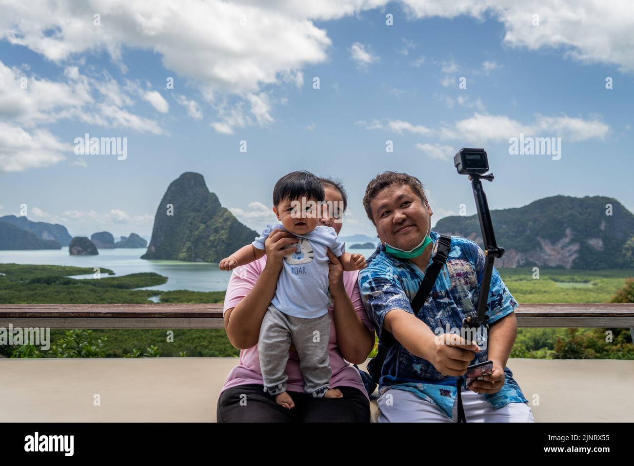 Phang Nga, Thailand. 13th Aug, 2022. A family poses for a selfie in front of Phang Nga Bay. To ...