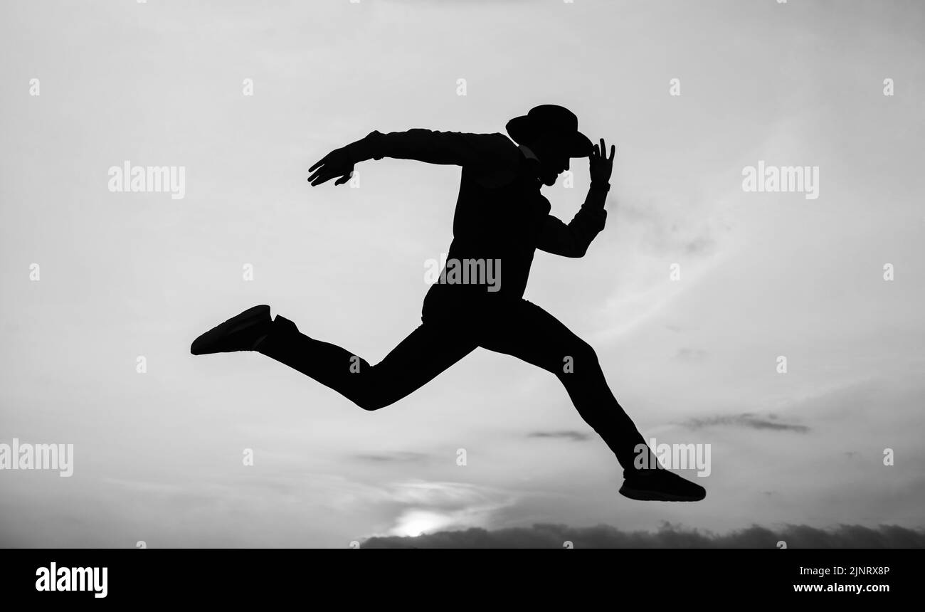 silhouette of man running in sense of freedom on sunrise sky, stamina ...