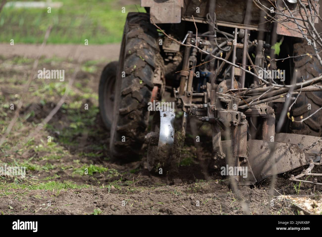 farm tractor with plow plows the field and prepares for sowing Stock ...