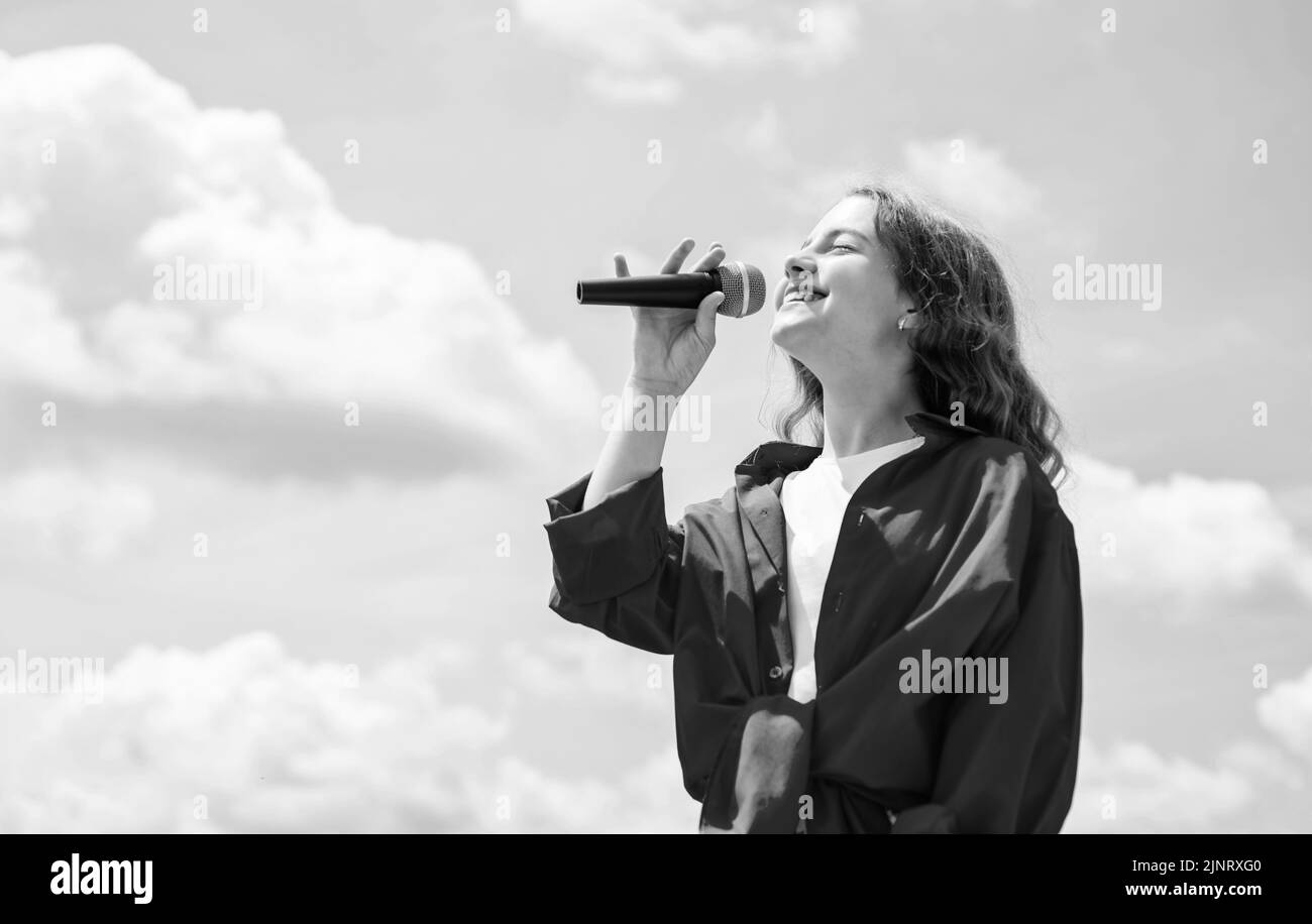 Cute and stylish. having a party. Happy kid with microphone. Singing ...
