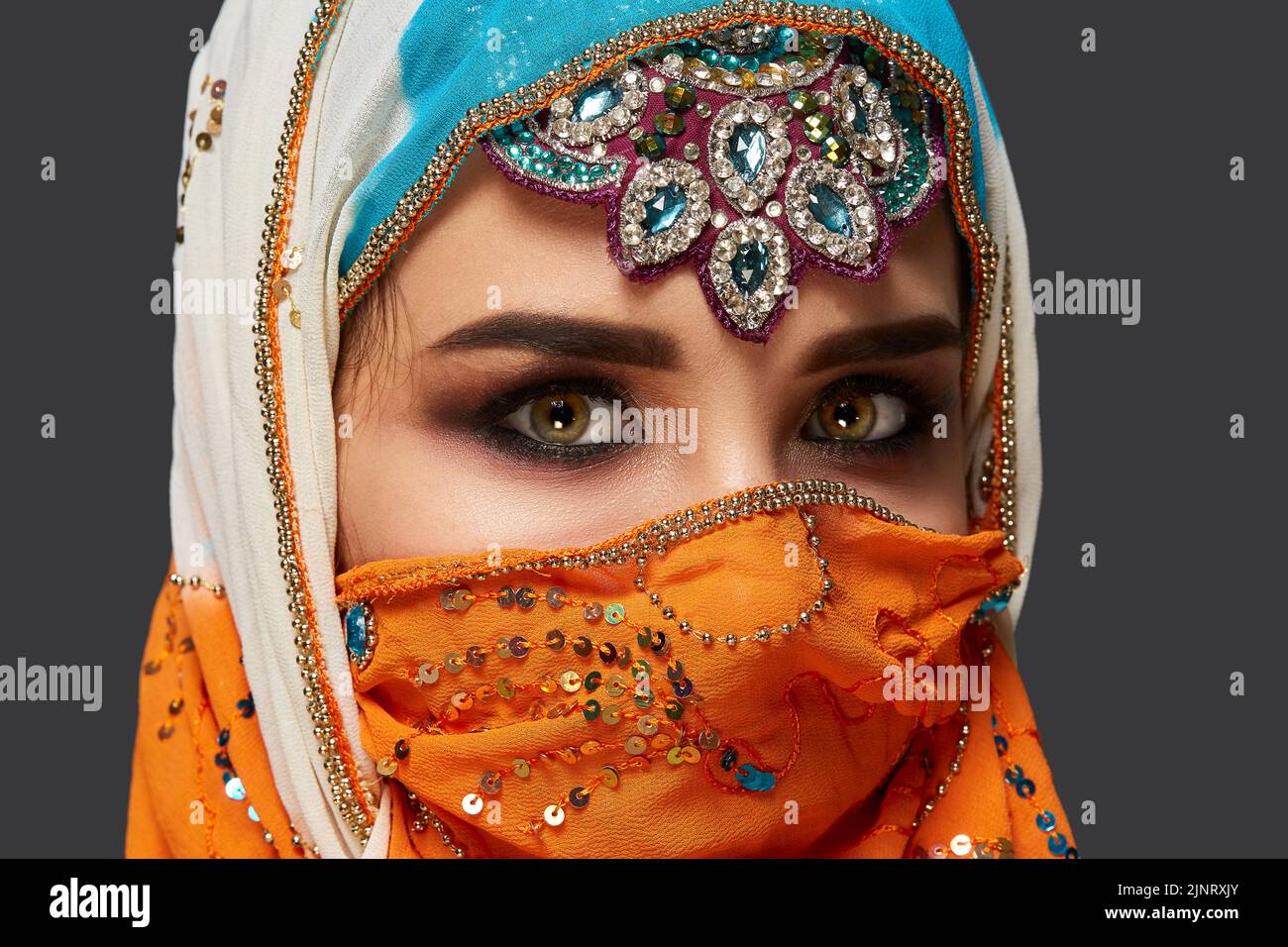 Studio shot of a chrming female wearing the colorful hijab decorated ...