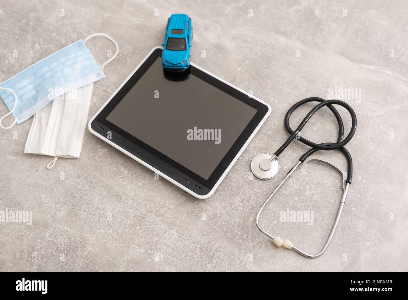 Medical equipment: stethoscope and tablet on grey background Stock ...