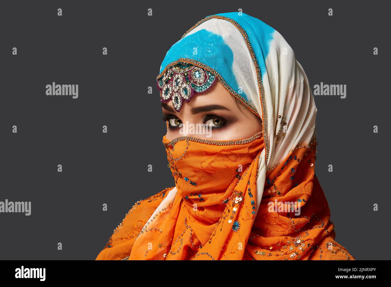 Studio shot of a chrming female wearing the colorful hijab decorated ...