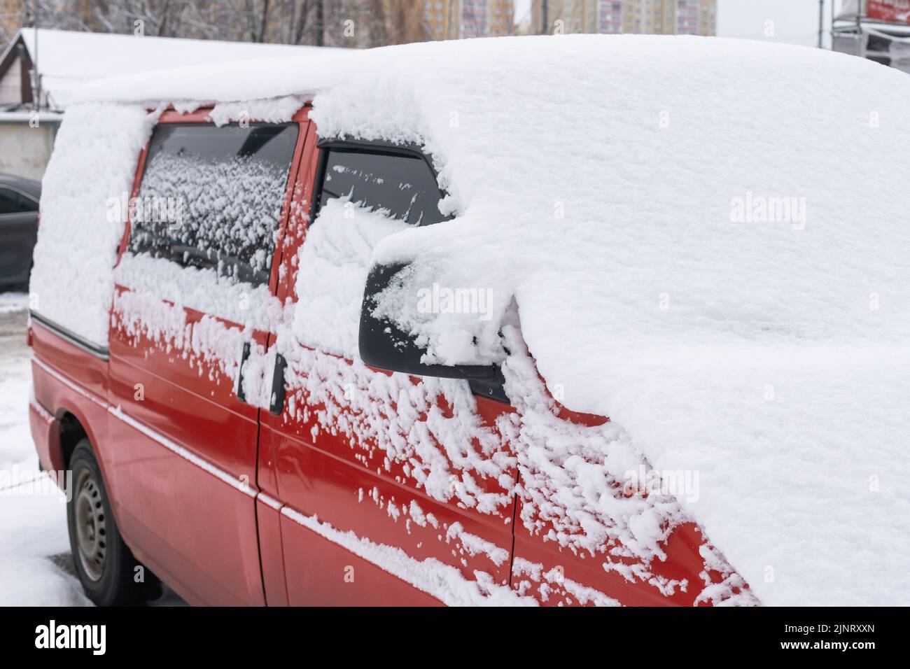 Frozen car covered snow at winter day, view front window windshield and ...