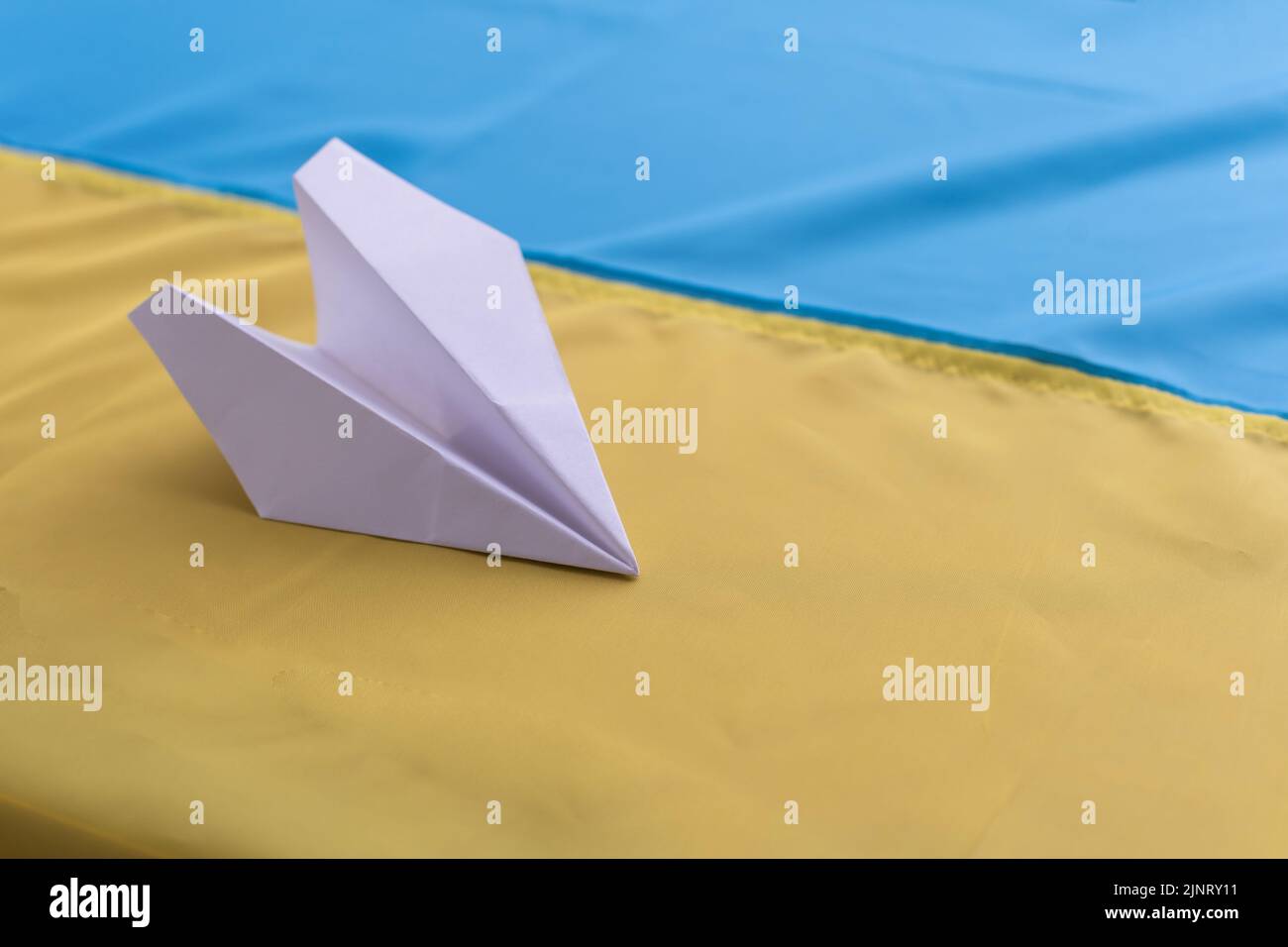 paper airplane on the background of the flag of Ukraine Stock Photo - Alamy