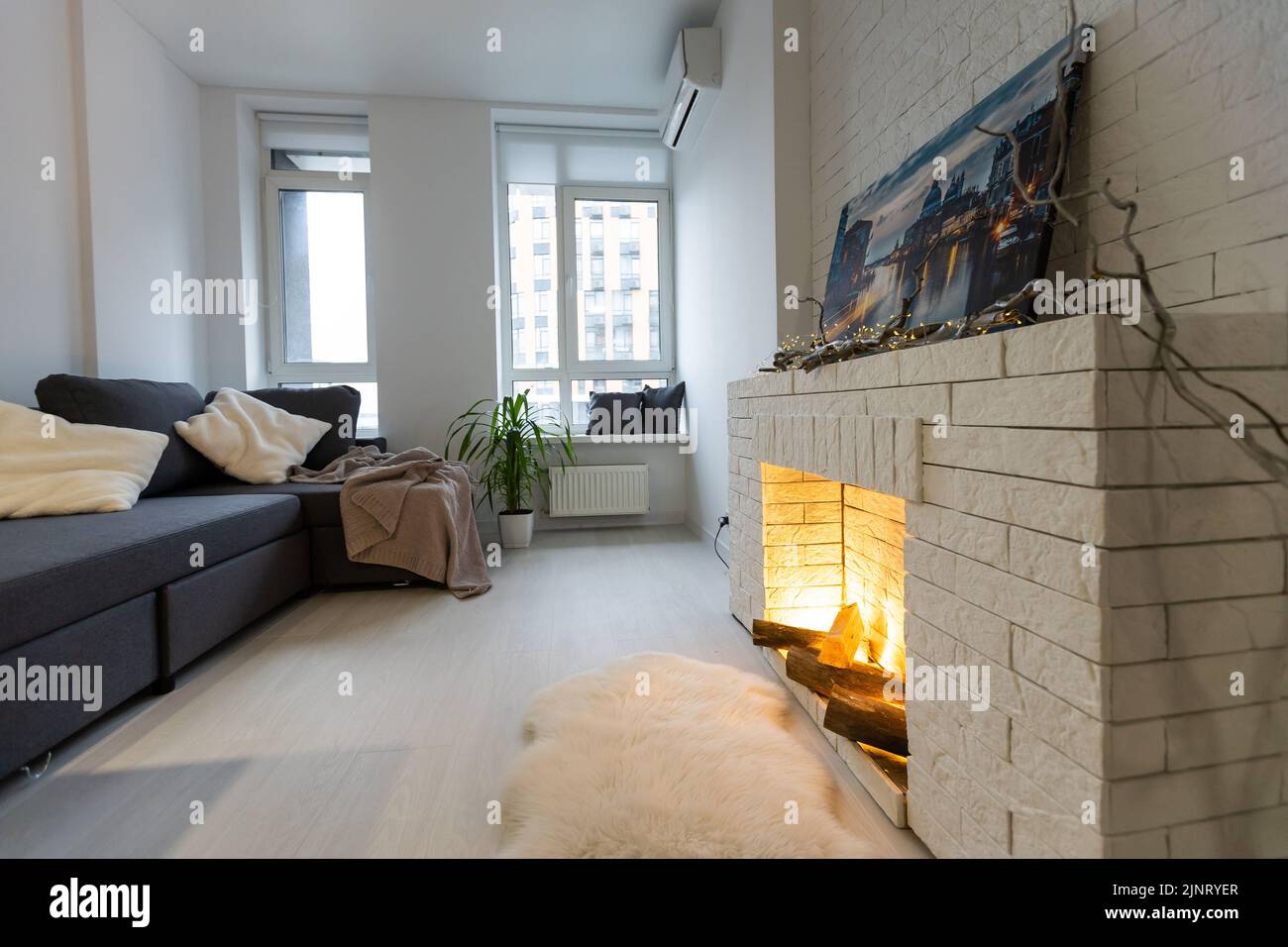 Bright living room interior with fireplace Stock Photo - Alamy