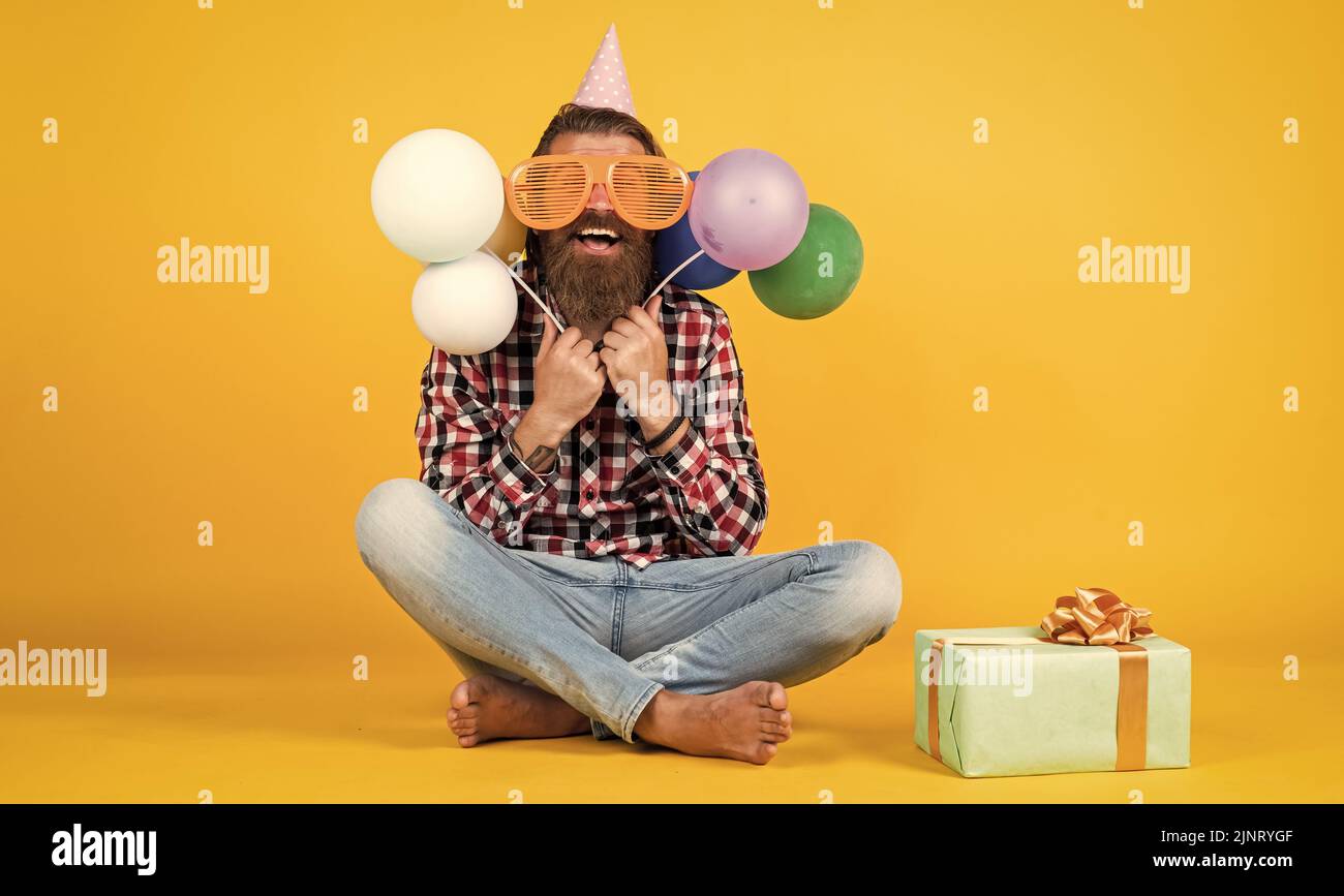surprise. happy man holding colorful helium balloons. hipster smiling ...
