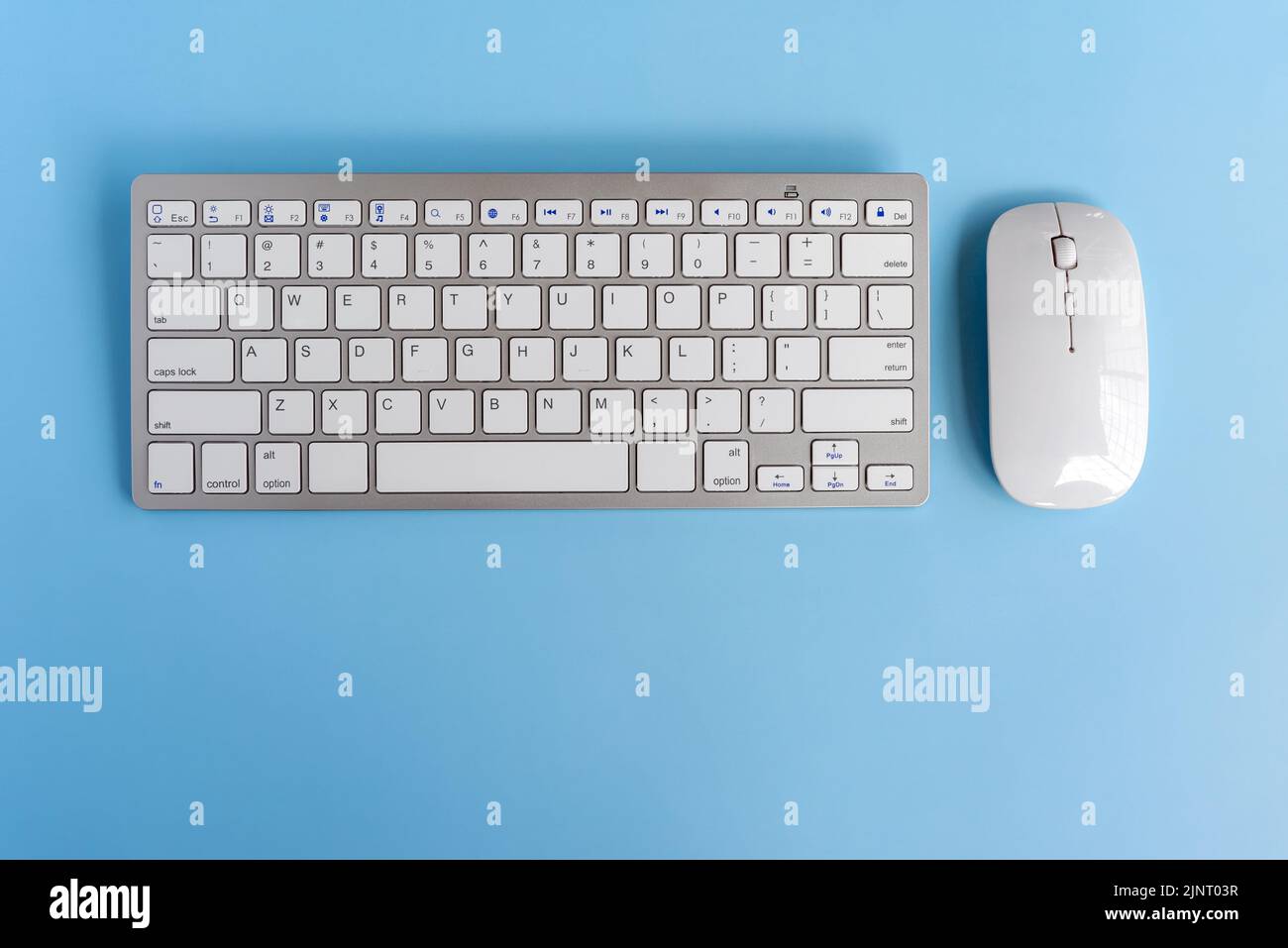 Computer keyboard and mouse on top of blue background desk Stock Photo ...