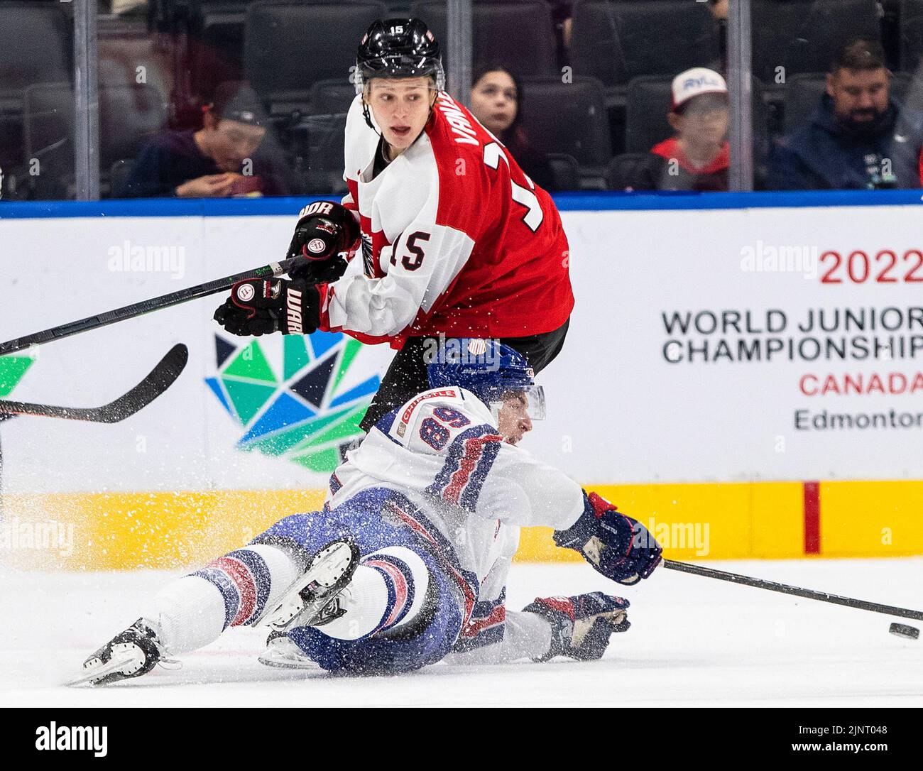 USA's Matt Knies (89) is checked by Austria's Finn van Ee (15) during ...