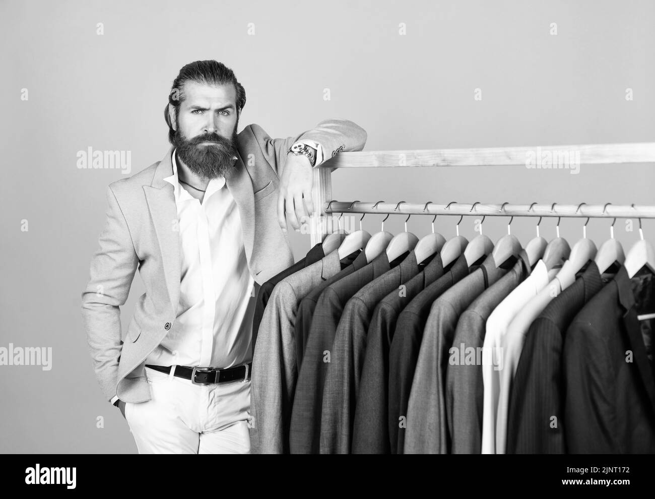 elegant businessman choose elegant apparel for formal event. atelier or ...