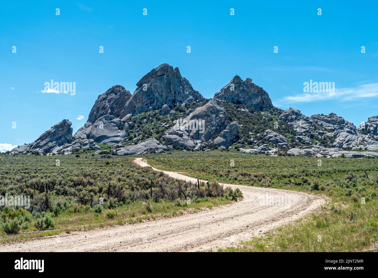 A dirt road leads to granite outcroppings at the City of Rocks National ...