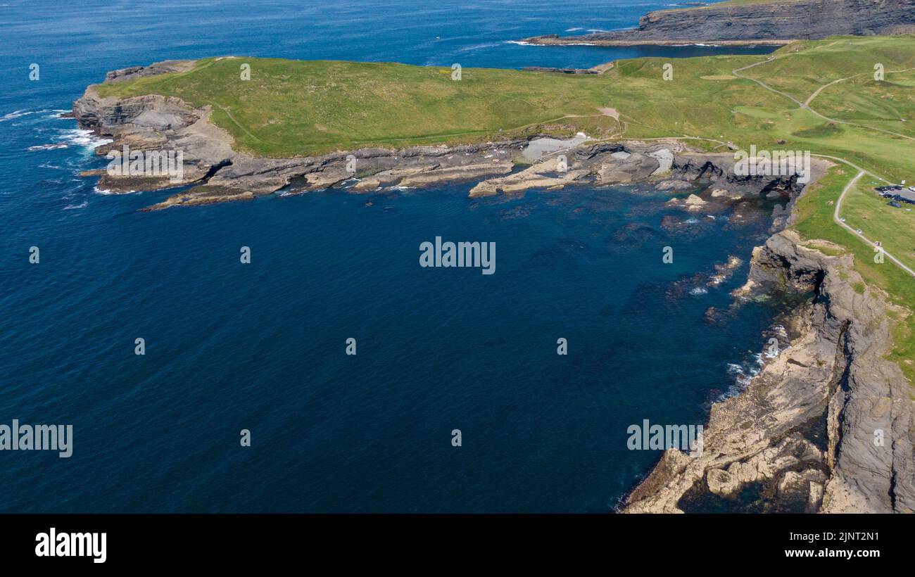 Kilkee town and public beach and surrounding cliffs around the crystal ...