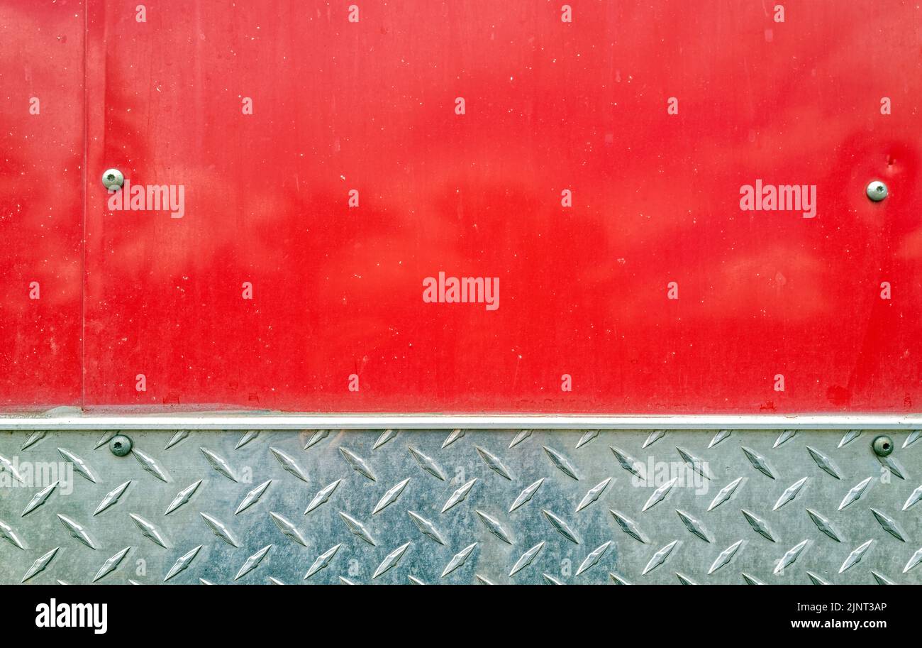 Red metal and diamond plates on the side of a horse trailer Stock Photo ...