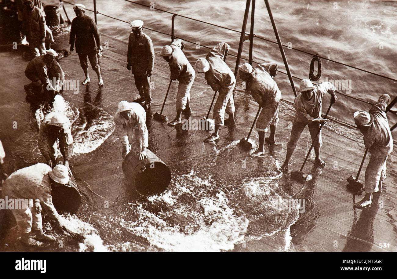 Italian sailors cleaning the main ceck of an italian warship during ...