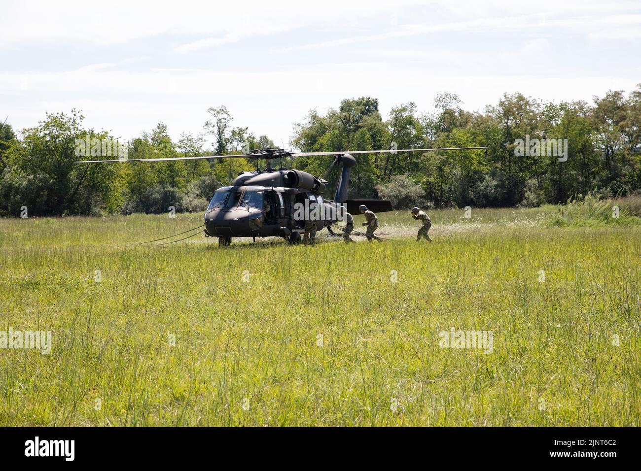 Soldiers board a UH-60 Black Hawk helicopter in preparation for their ...