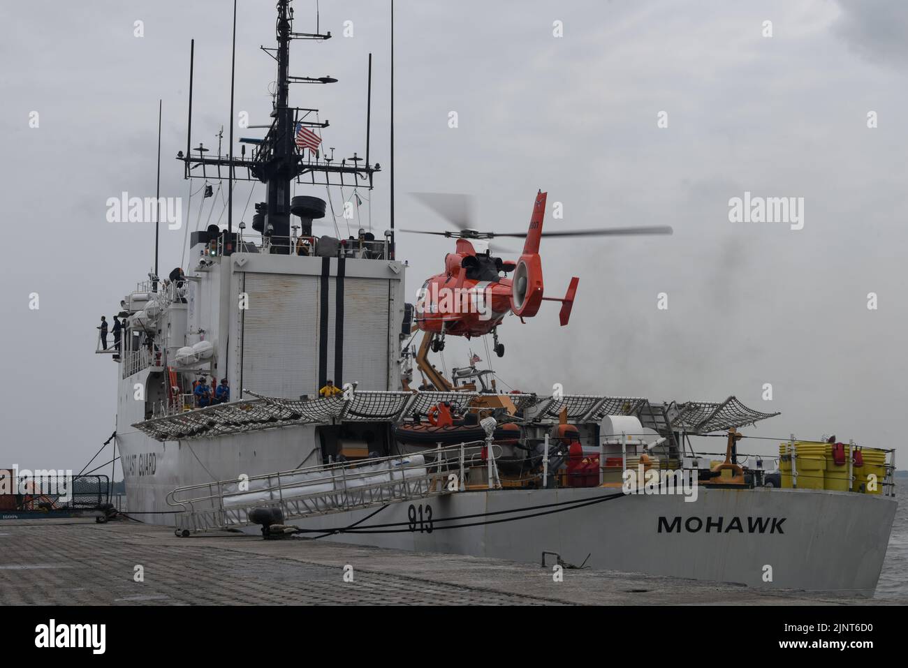 A MH-65 Dolphin helicopter from Coast Guard Air Station Houston lands ...